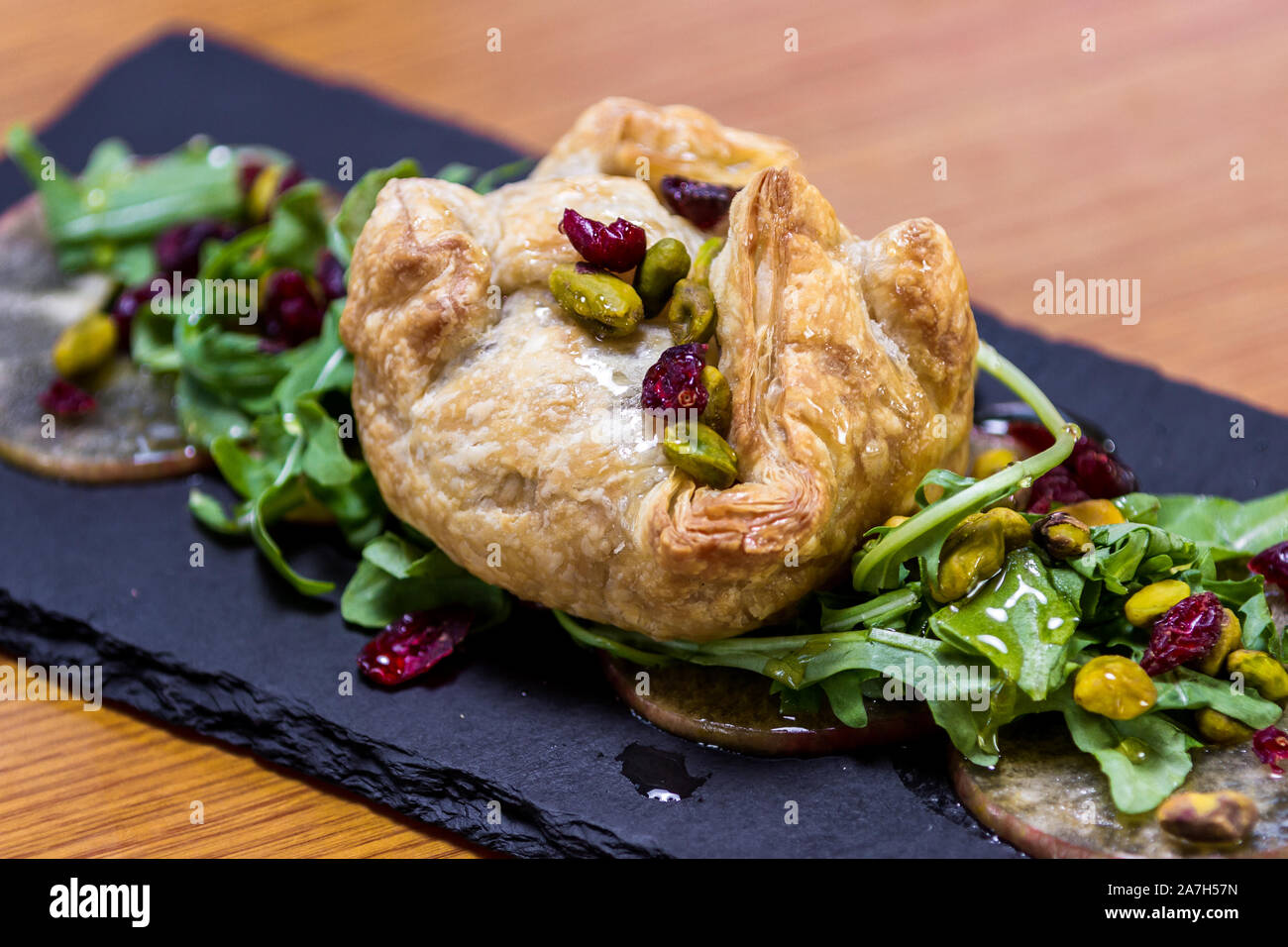 baked brie stuffed in a puff pastry served with seasonal fruit and ...