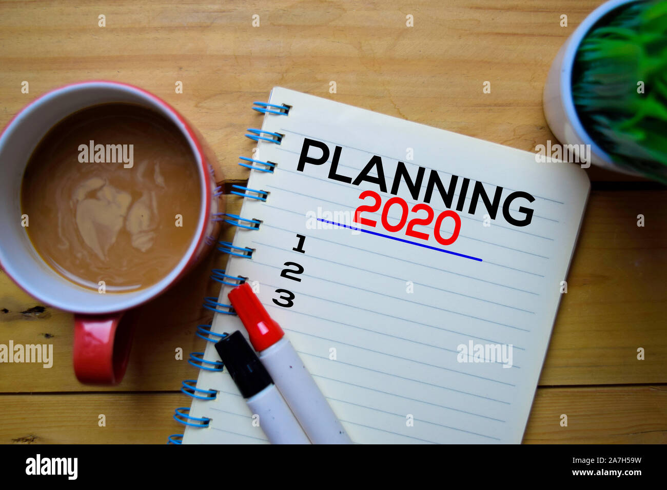 Planning 2020 write on the book with wooden table background Stock ...