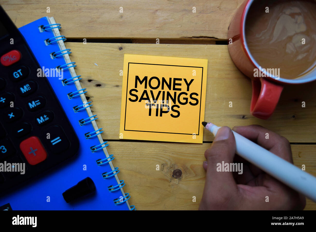 Money Savings Tips write on sticky note with wooden table background ...