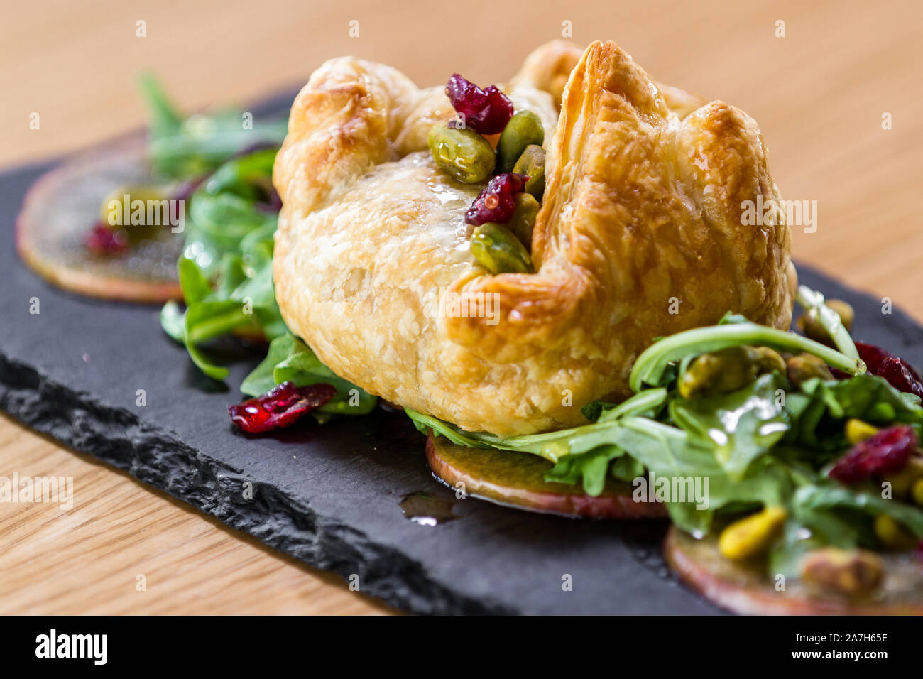 baked brie stuffed in a puff pastry served with seasonal fruit and ...