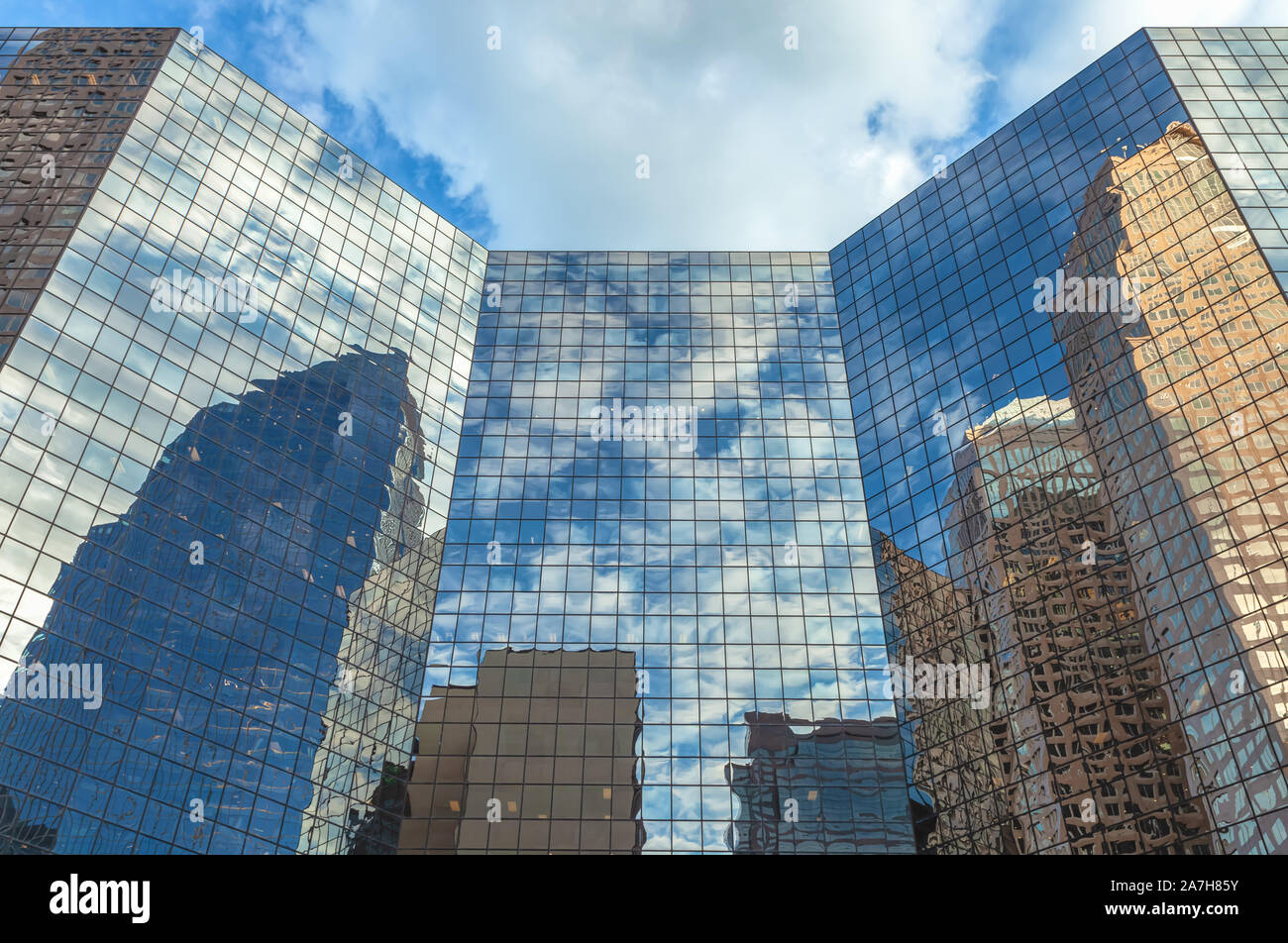 Reflections of the city high rises on the building exterior glass ...