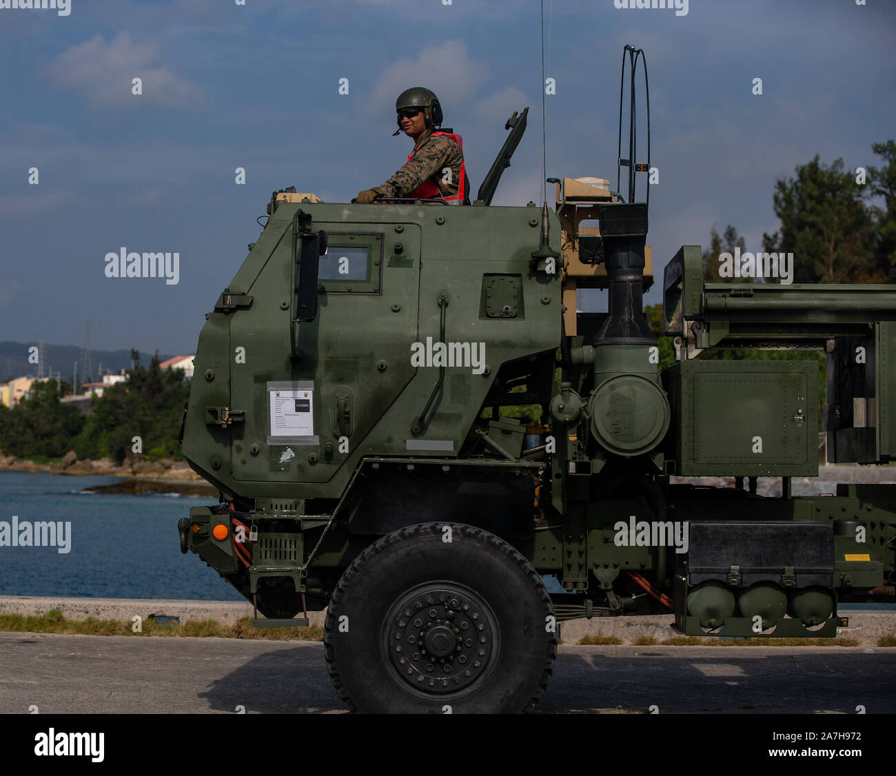 U.S. Marines with 12th Marine Regiment, 3rd Marine Division, drive a ...