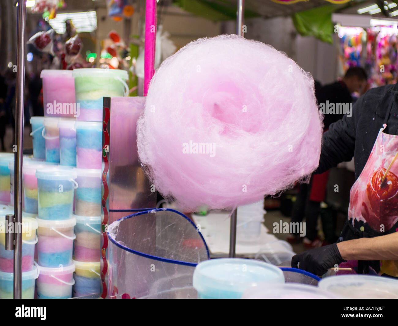 Man making cotton candy at funfair stand Stock Photo - Alamy