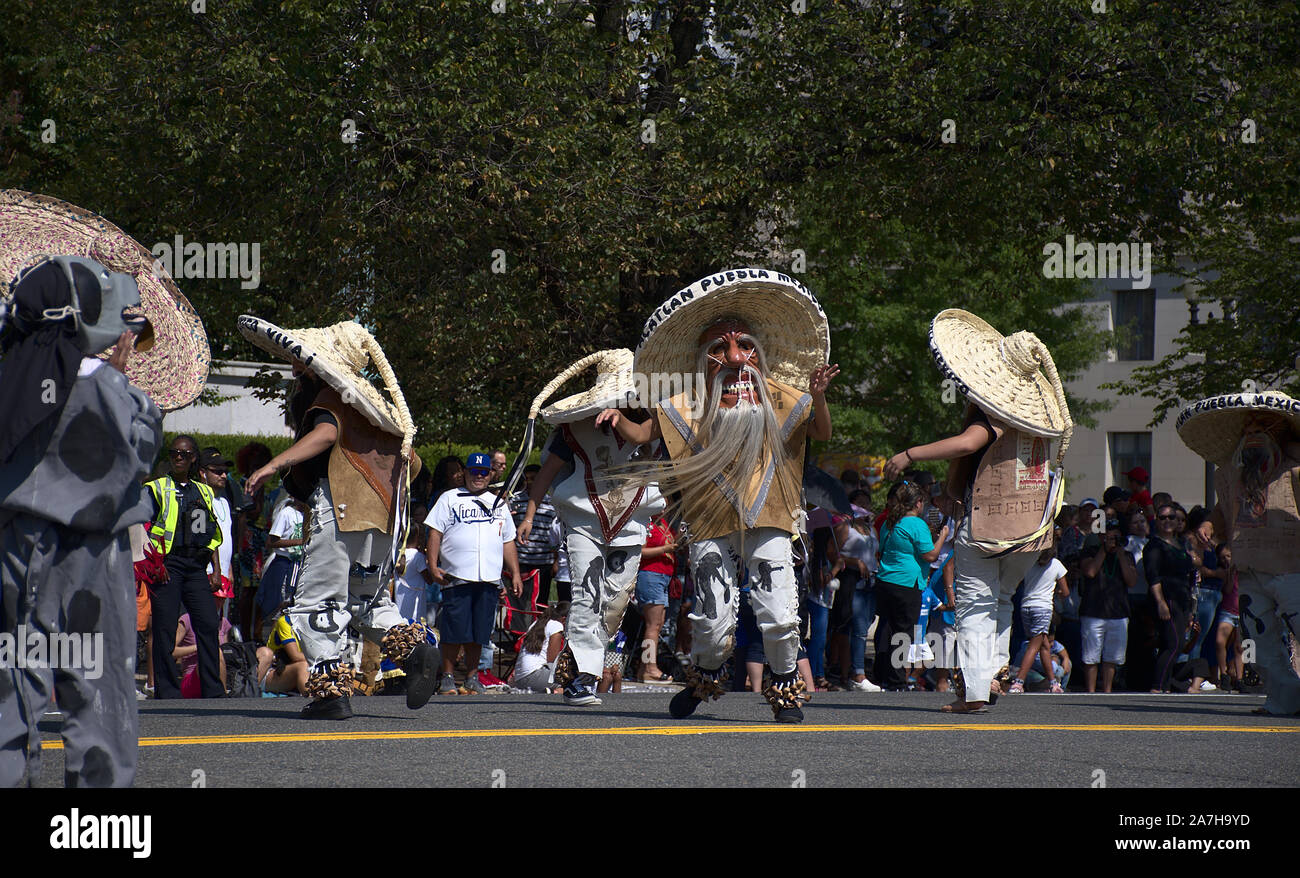 People dressed in costume with large sombrero and mask with long beard ...