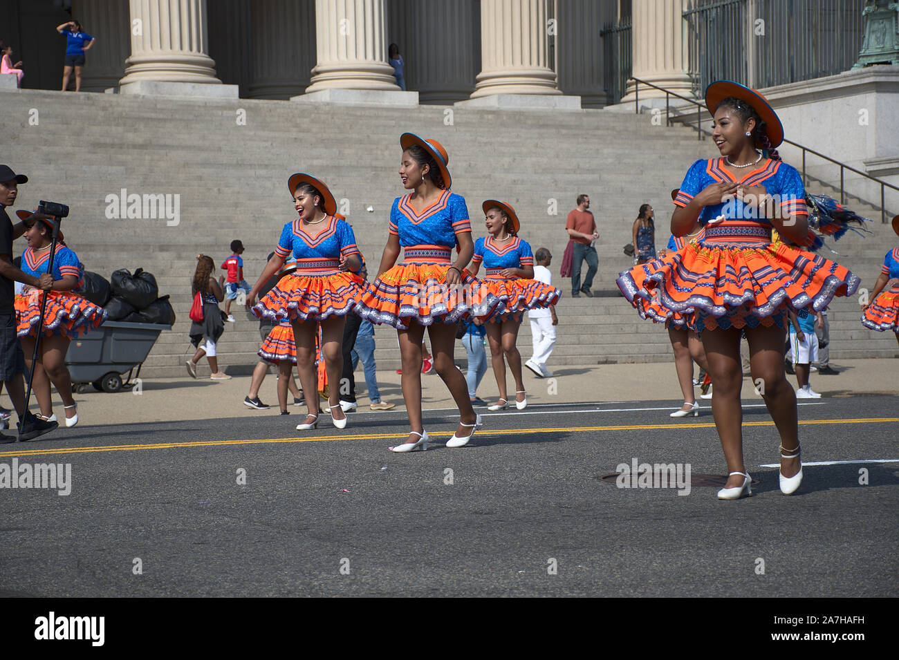 Females with South American heritage dancing in colorful costumes with ...