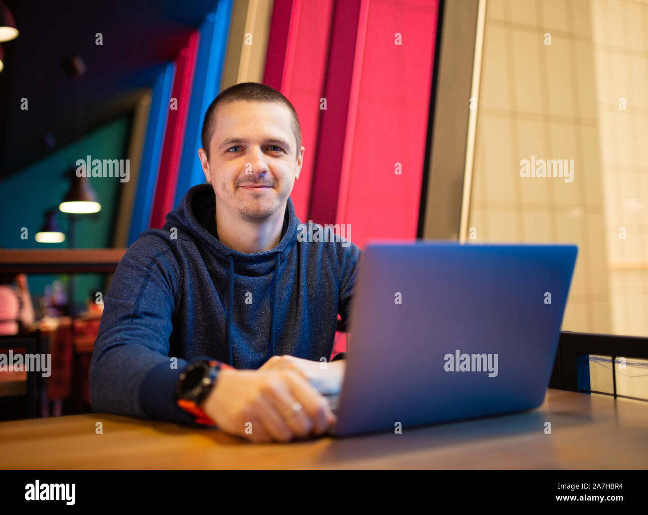 Adult man freelancer with laptop in cafe Stock Photo - Alamy