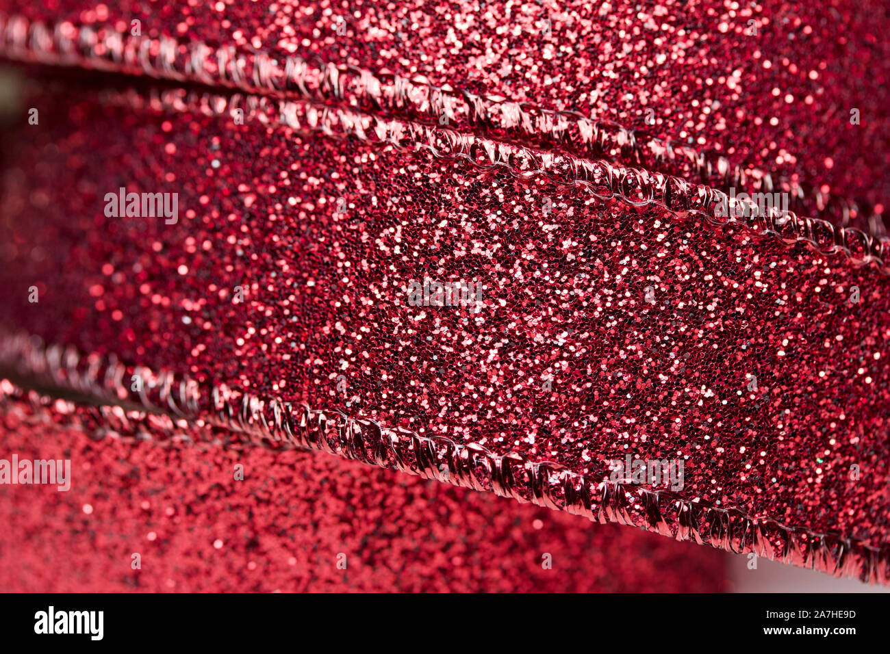 Macro background of brightly lit beautiful sparkling red glitter fabric ...