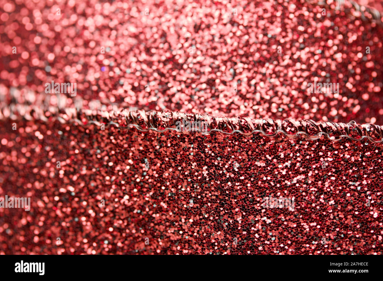 Macro background of brightly lit beautiful sparkling red glitter fabric ...
