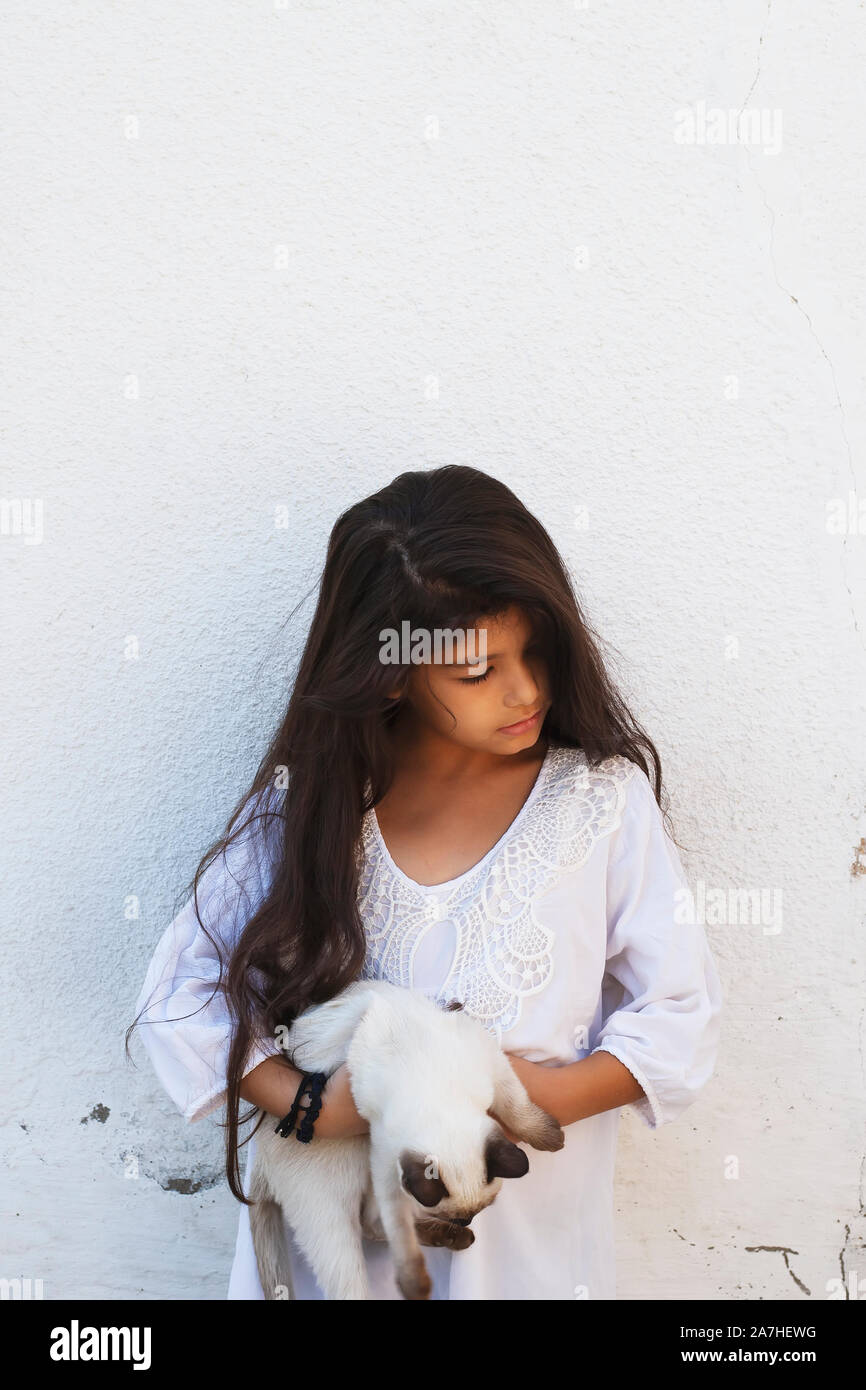 Happy girl hugging lovely kitten. Cute 12 years kid girl holding a ...