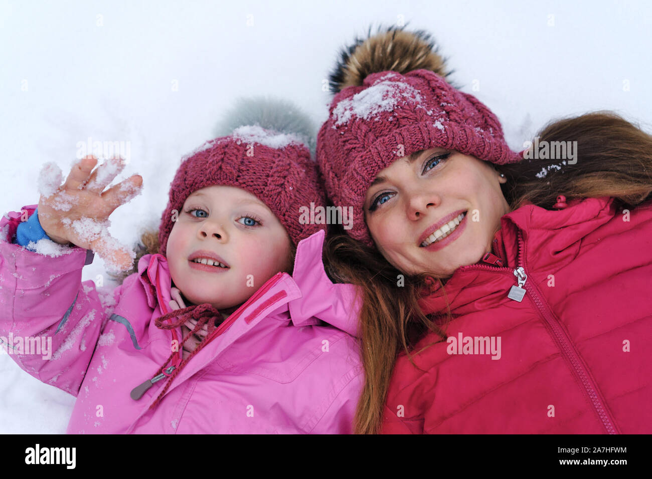 Fashionable stylish family having fun playing in snow. Weekends ...