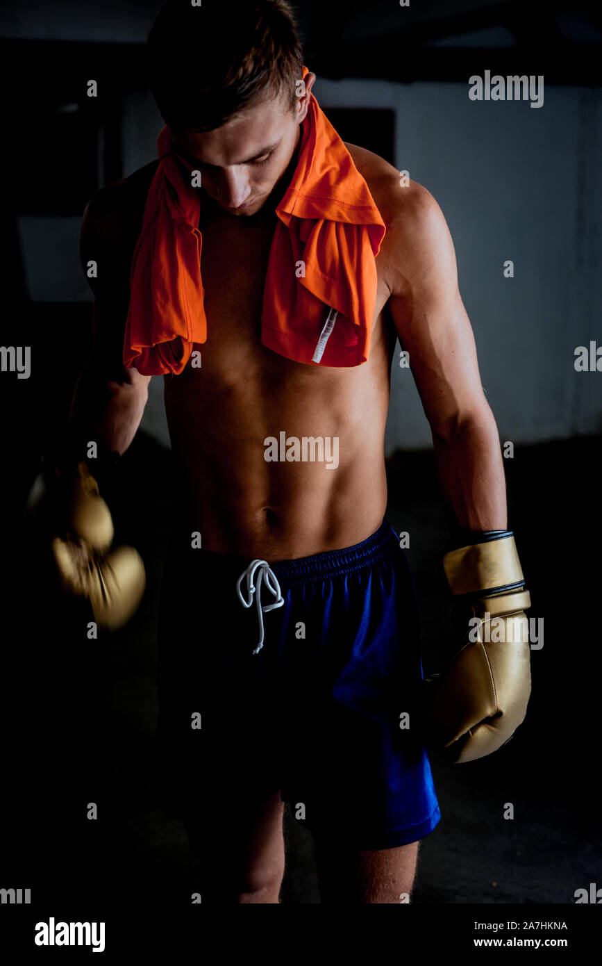 Shirtless man in boxing gloves after hard boxing training Stock Photo ...