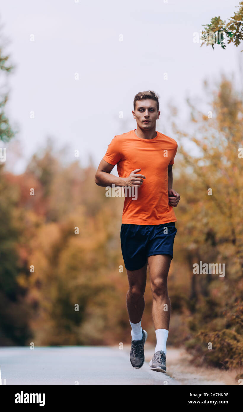 Portrait of a healthy sports man jogging outdoors in nature Stock Photo ...