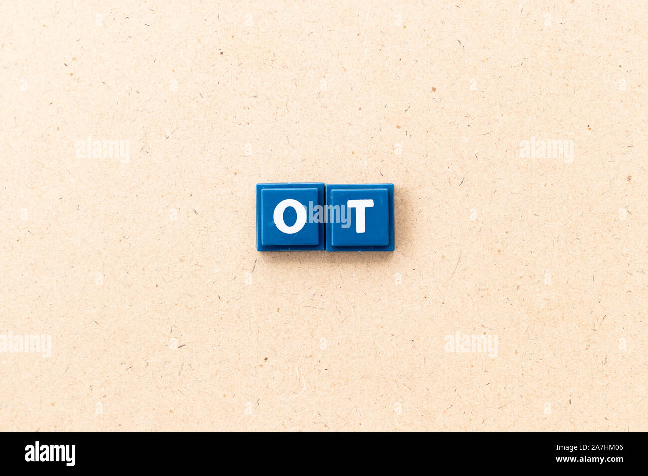 Tile letter in word ot (abbreviation for overtime) on wood background ...