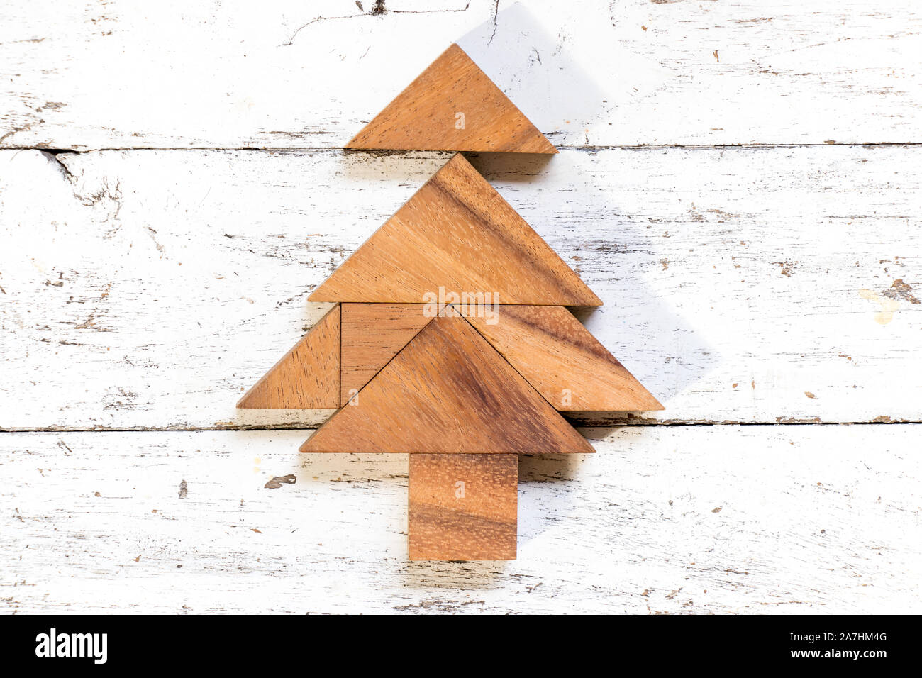 Tangram puzzle in christmas or pine tree shape on old white wood ...