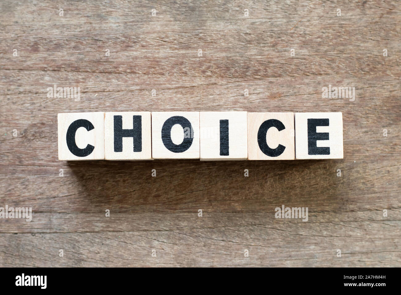 Letter block in word choice on wood background Stock Photo - Alamy