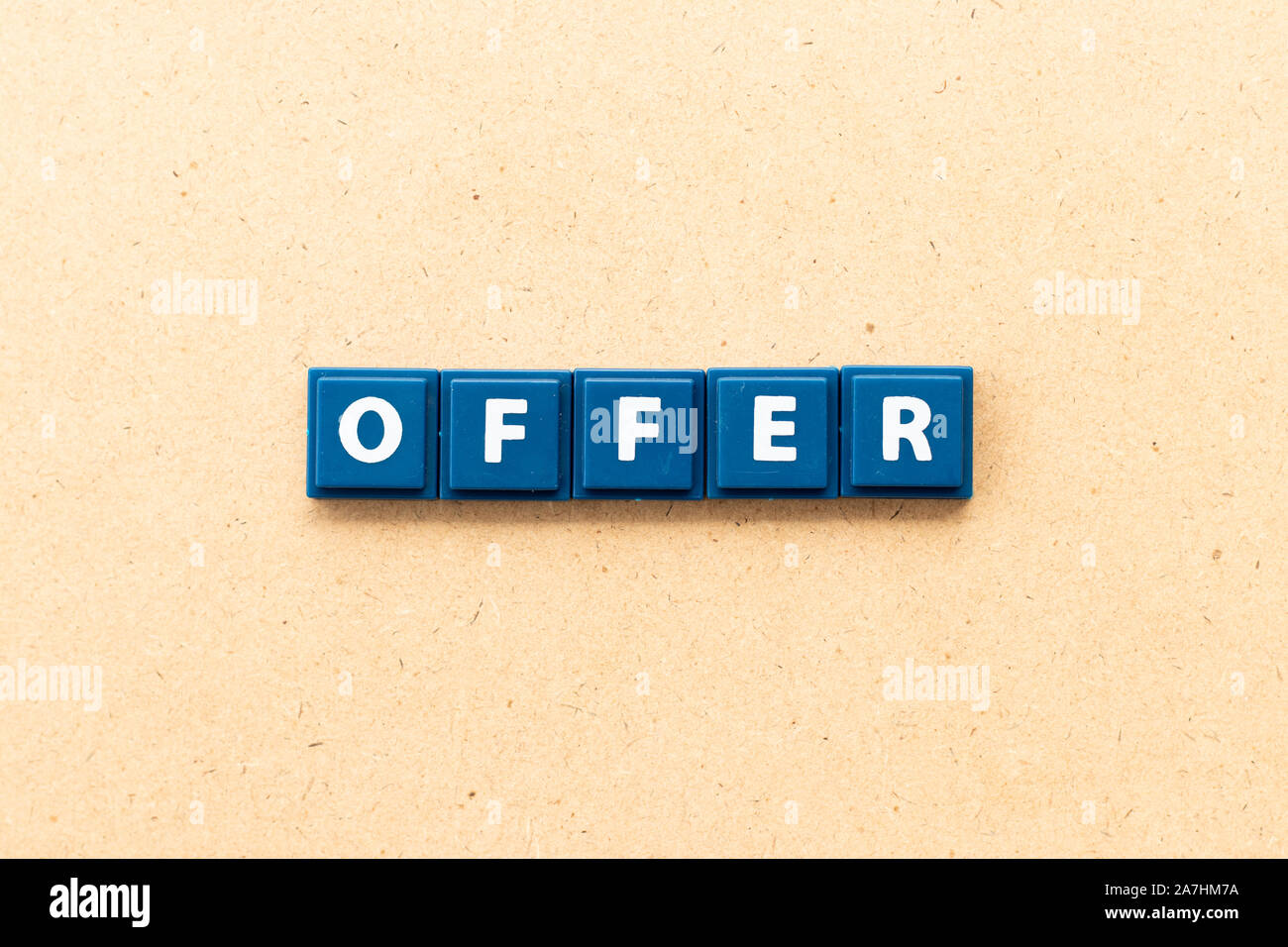 Tile letter in word offer on wood background Stock Photo - Alamy