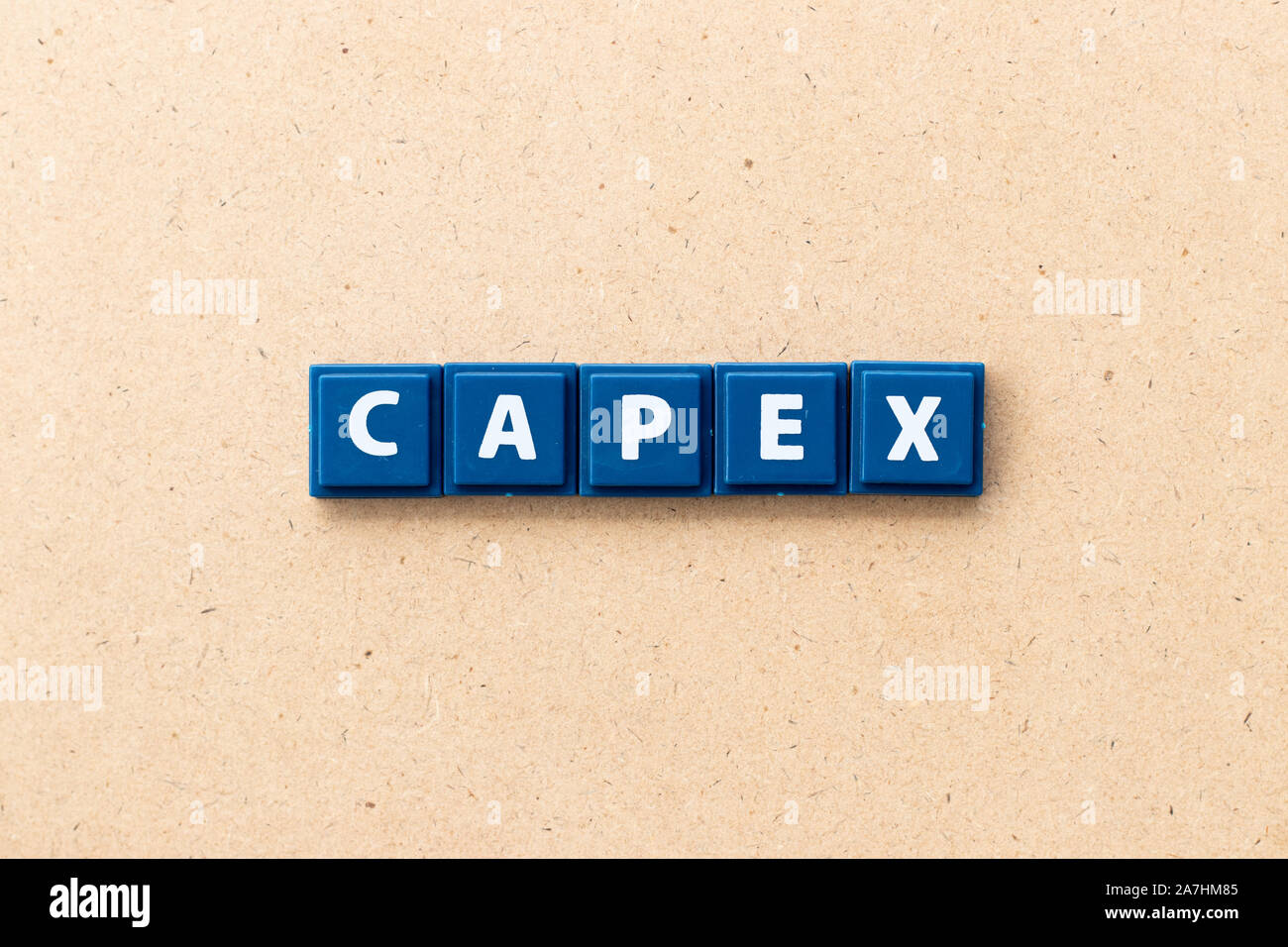 Tile letter in word CAPEX (Abbreviation of Capital Expenditure) on wood ...