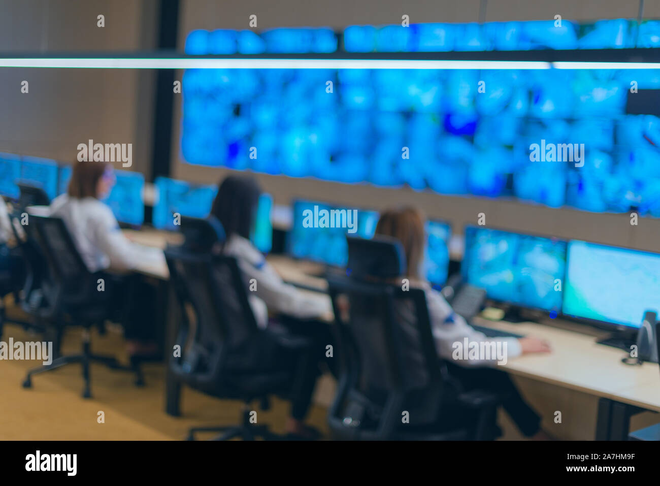 Female security guards working on computers while sitting in the main ...
