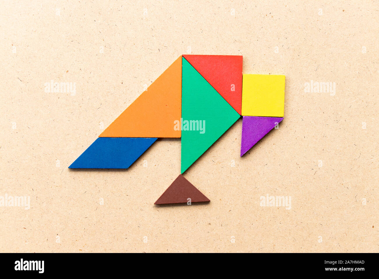 Color tangram puzzle in vulture bird shape on wood background Stock ...
