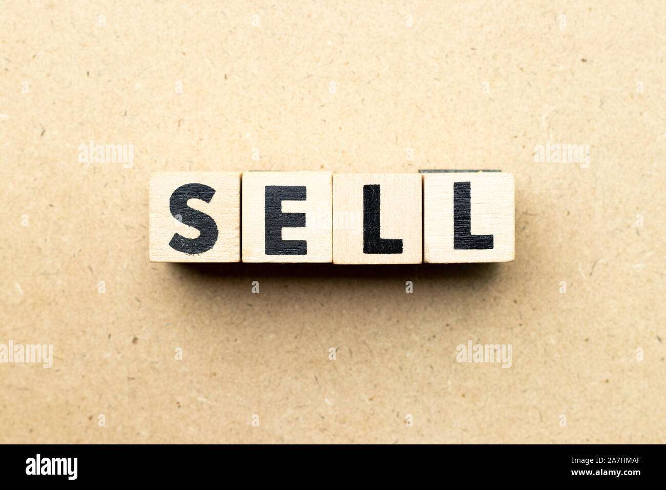 Letter block in word sell on wood background Stock Photo - Alamy