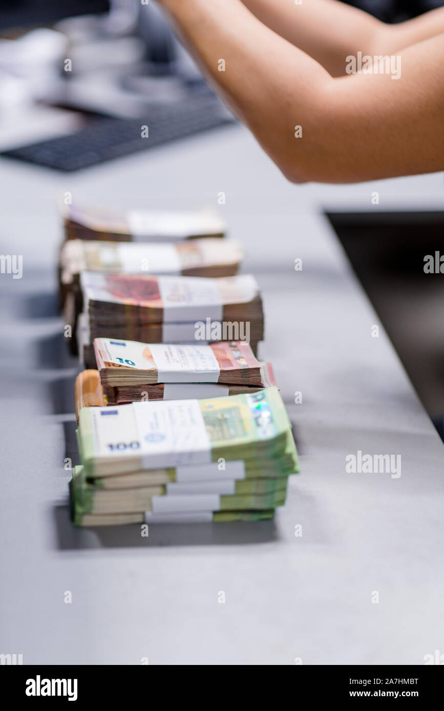 Money couner arranging various types of cash banknotes after it is ...