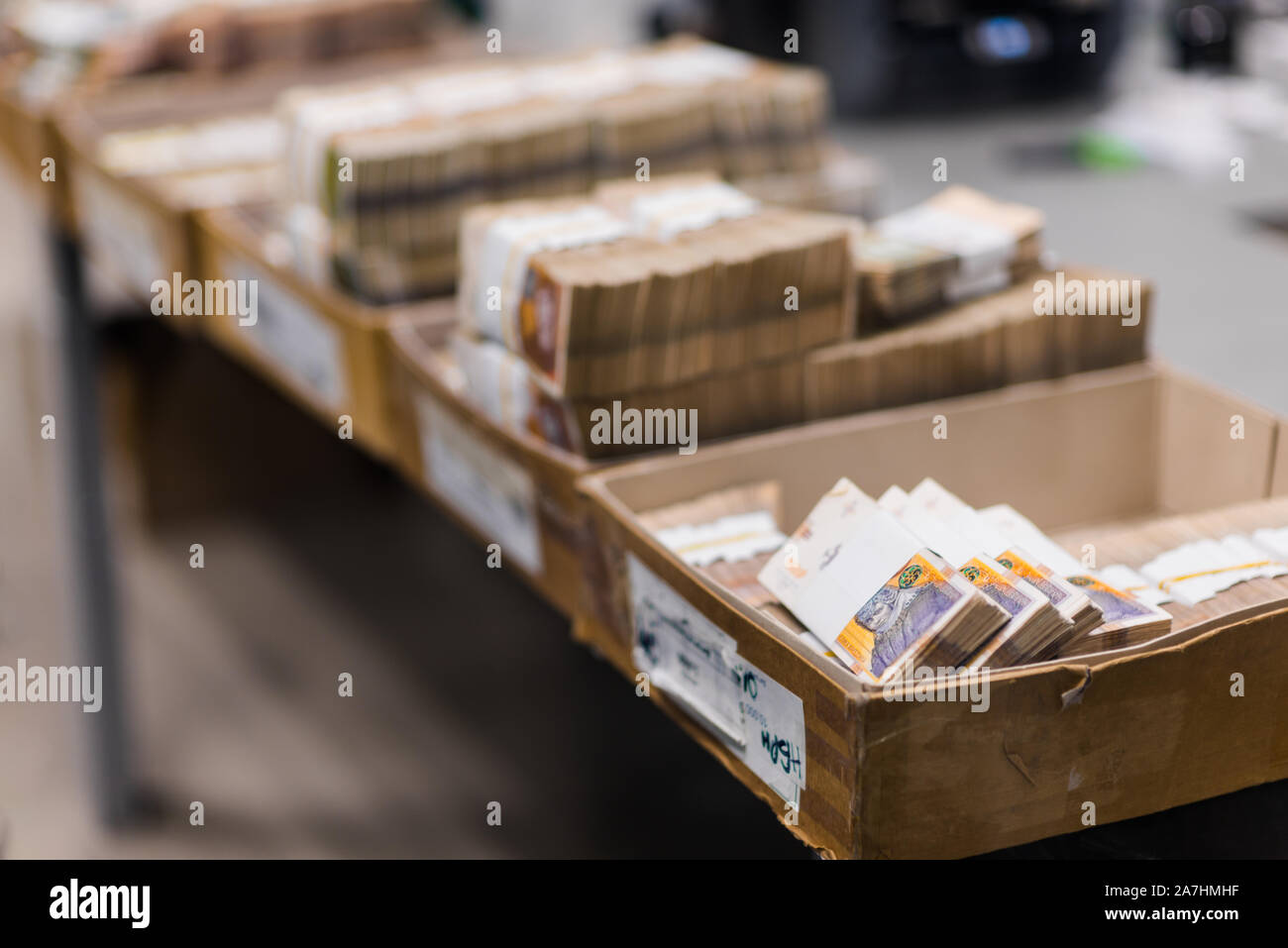 Carton boxes full of various types of binded banknotes with bill straps ...