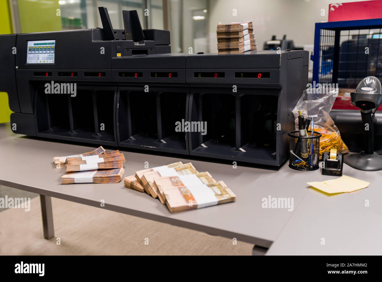 Banknotes stacked and binded together with currency bands in front of ...