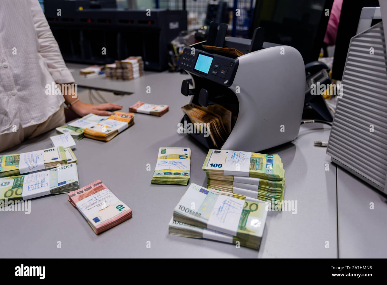 Large sum of various types of euro € banknotes on an office desk at the ...