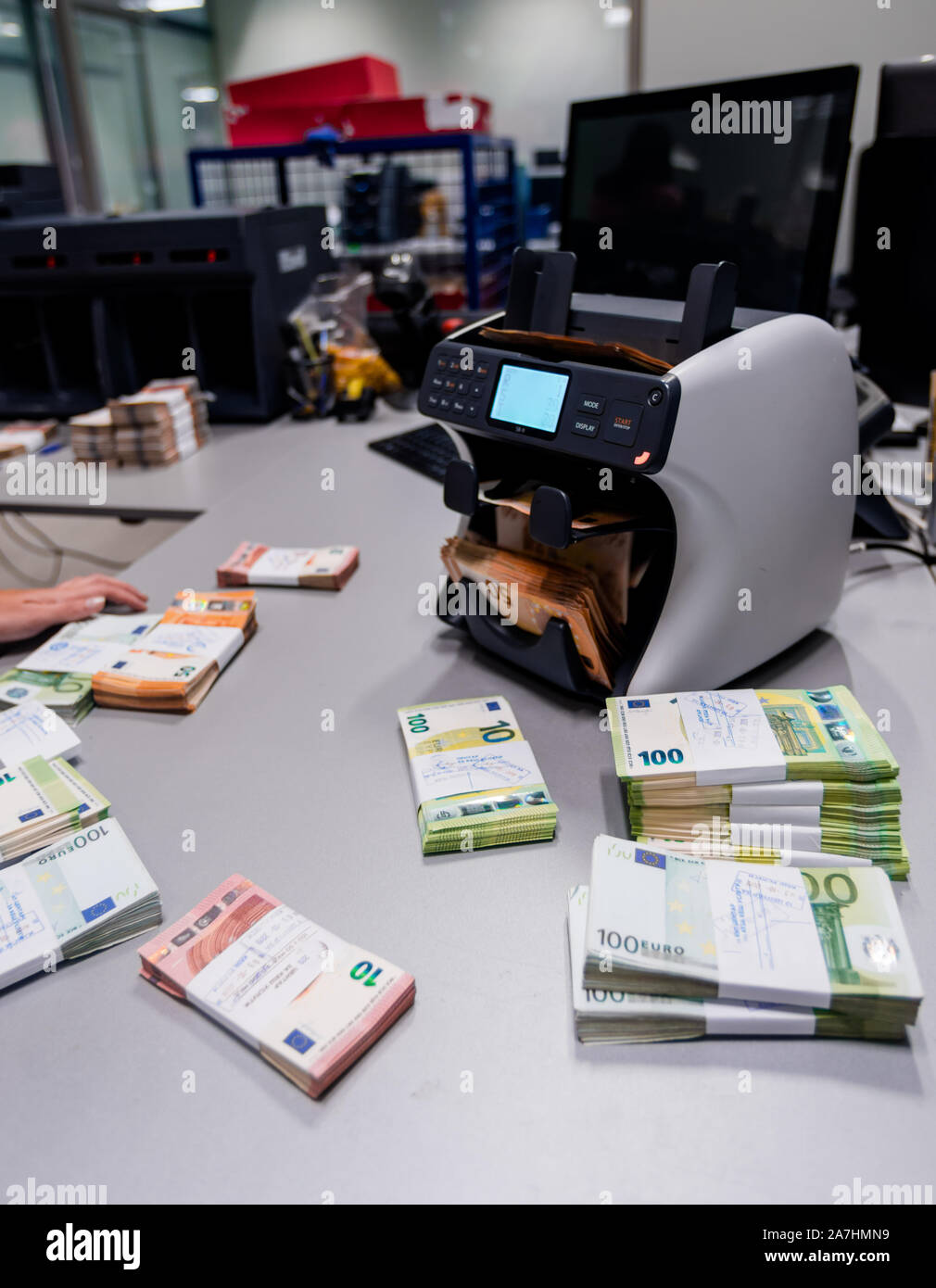 Large sum of various types of euro € banknotes on an office desk at the ...