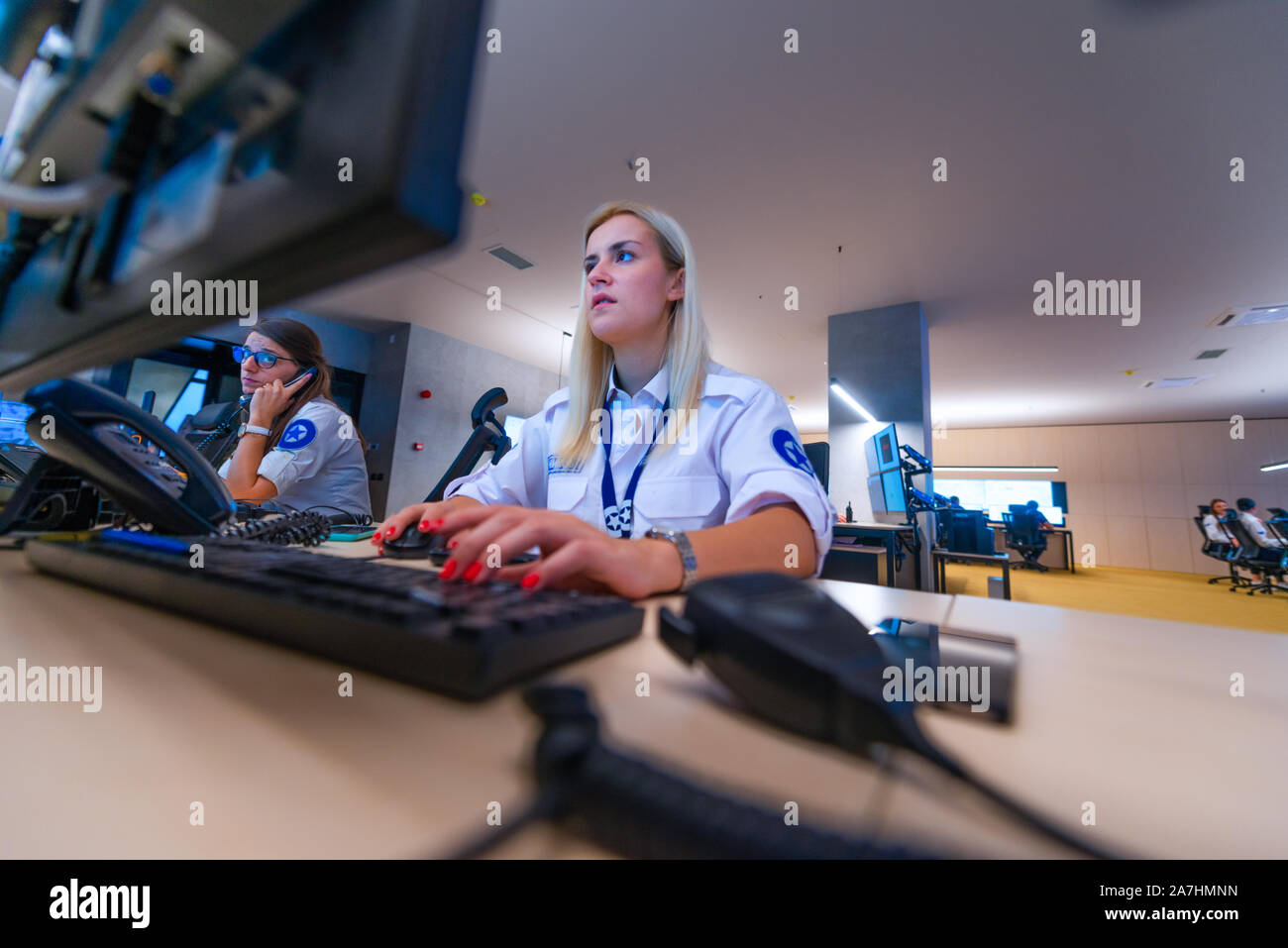 Female security operator working in a security data control room ...