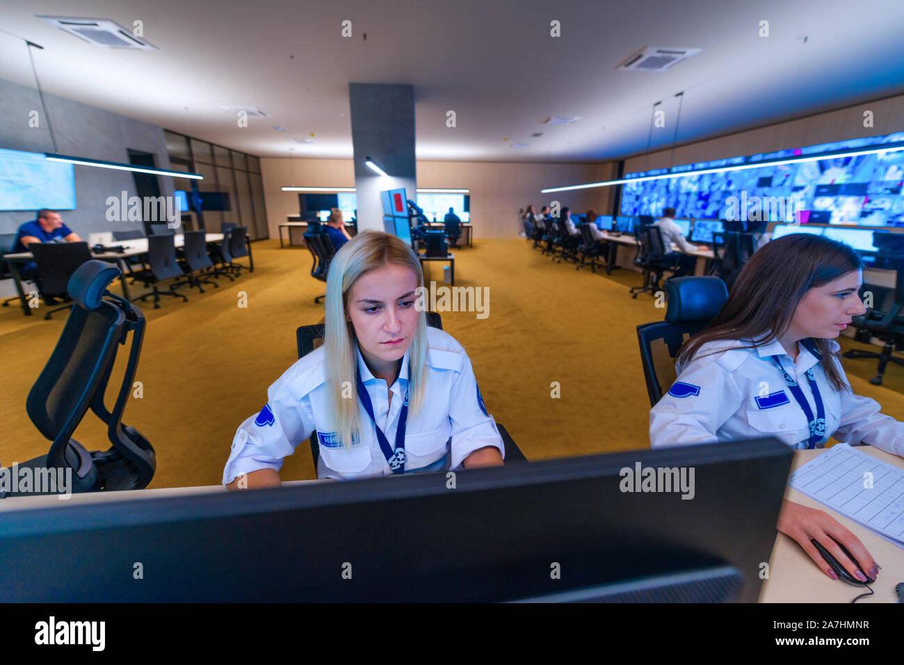 Female security operator working in a security data control room ...