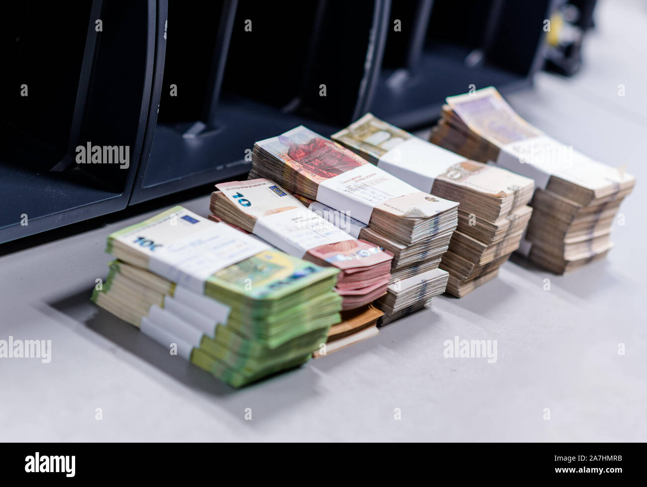 Bundles of banknotes divided into groups with currency straps placed on ...