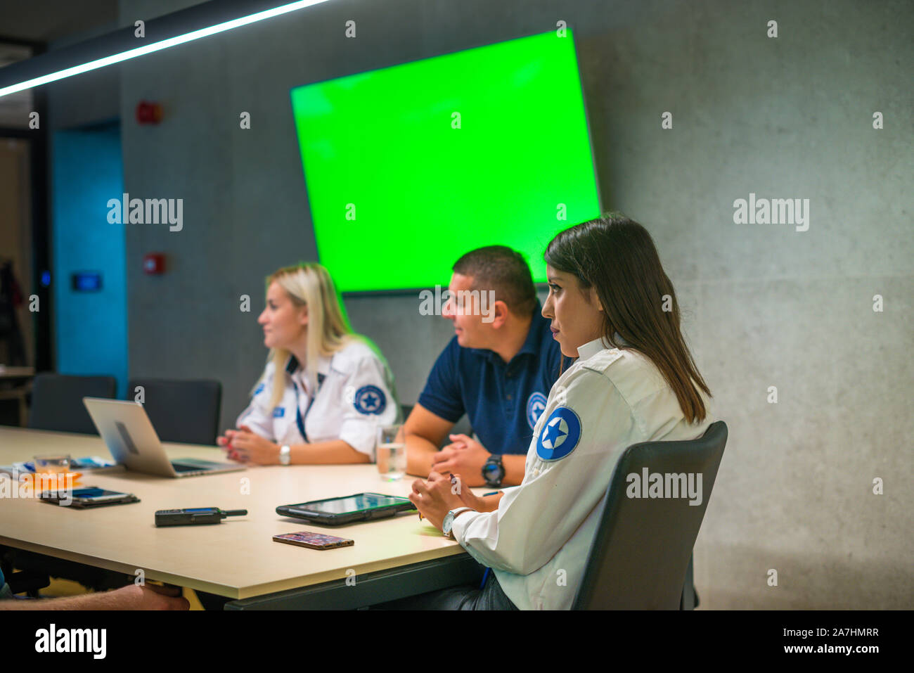 Security guard monitoring modern CCTV cameras in a surveillance room ...