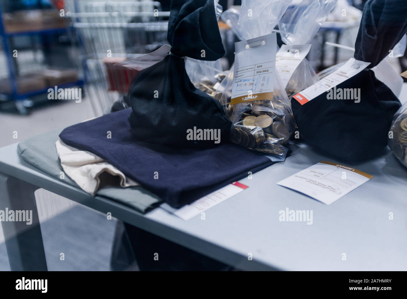 Seethrough and black bags filled with metal coins Stock Photo - Alamy