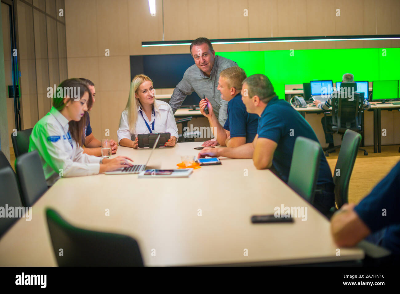 Security guard monitoring modern CCTV cameras in a surveillance room ...