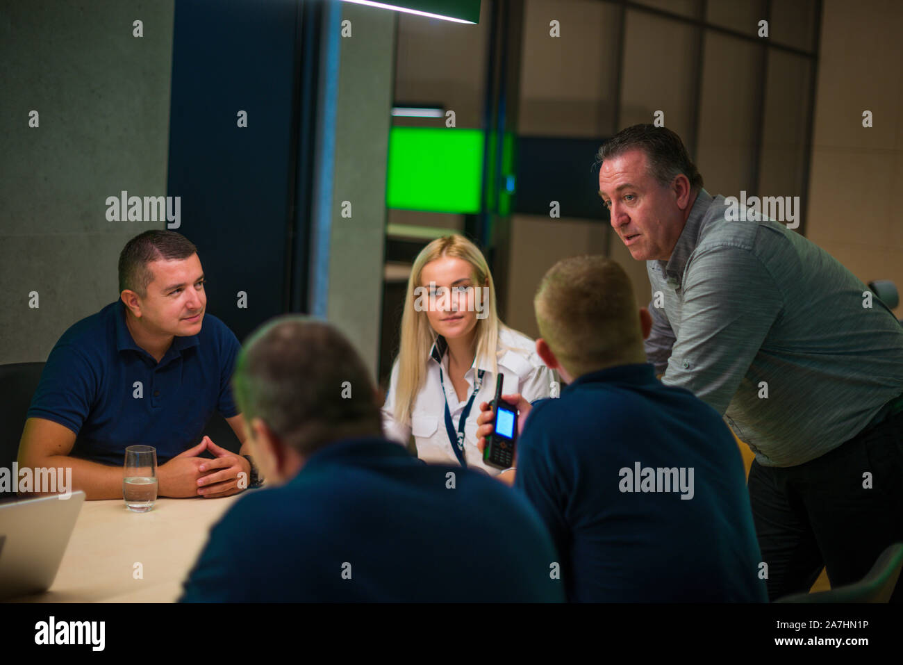 Security guard monitoring modern CCTV cameras in a surveillance room ...