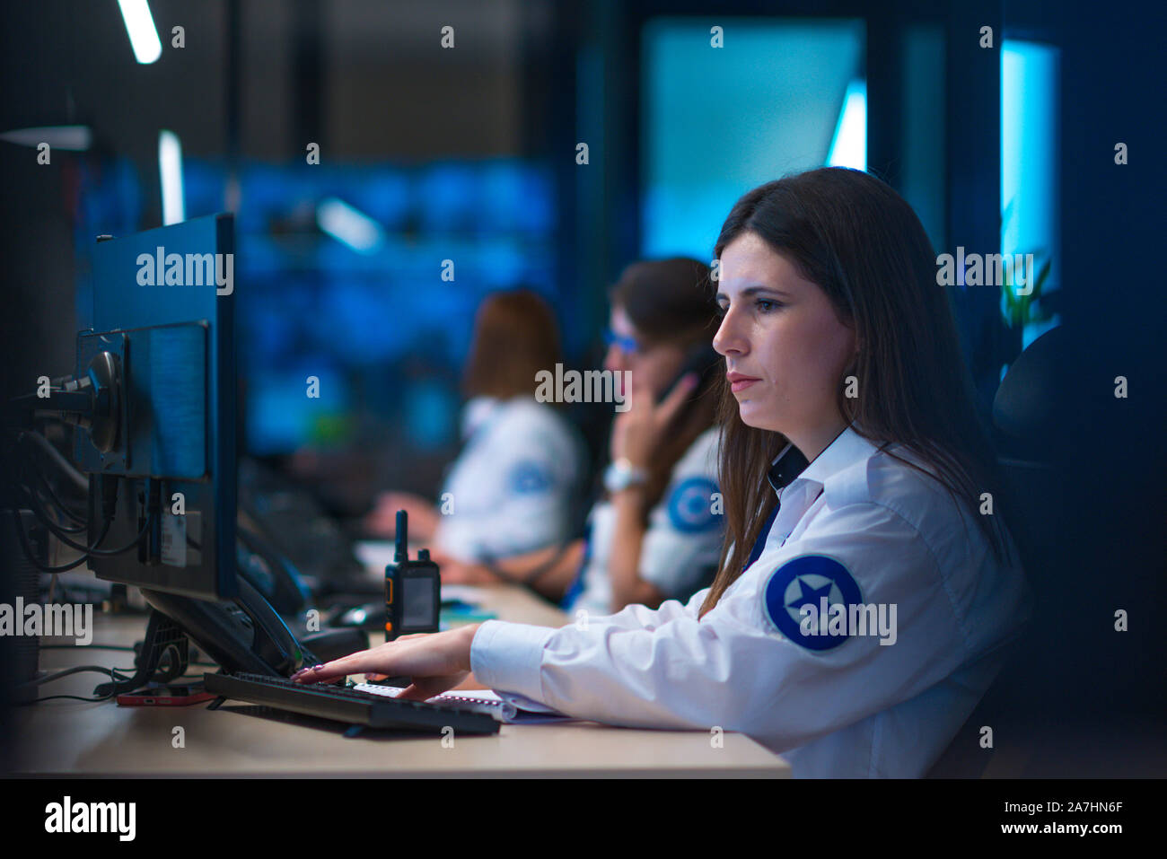 Security guard monitoring modern CCTV cameras in a surveillance room ...
