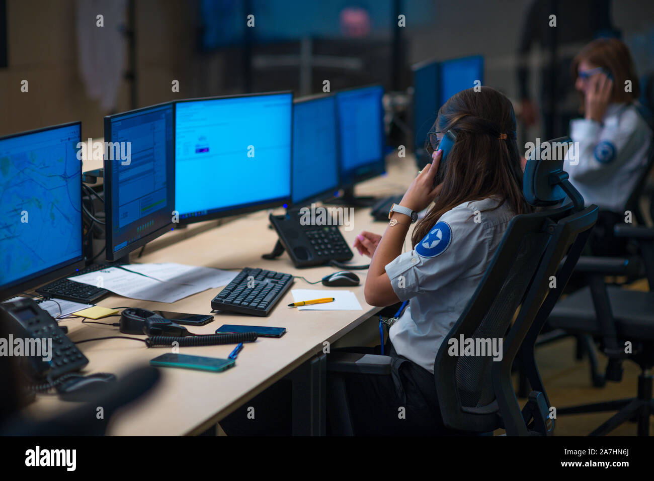 Security guard monitoring modern CCTV cameras in a surveillance room ...