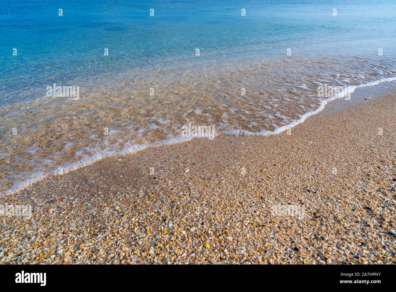 Calm sea shore with crystal clear water Stock Photo - Alamy