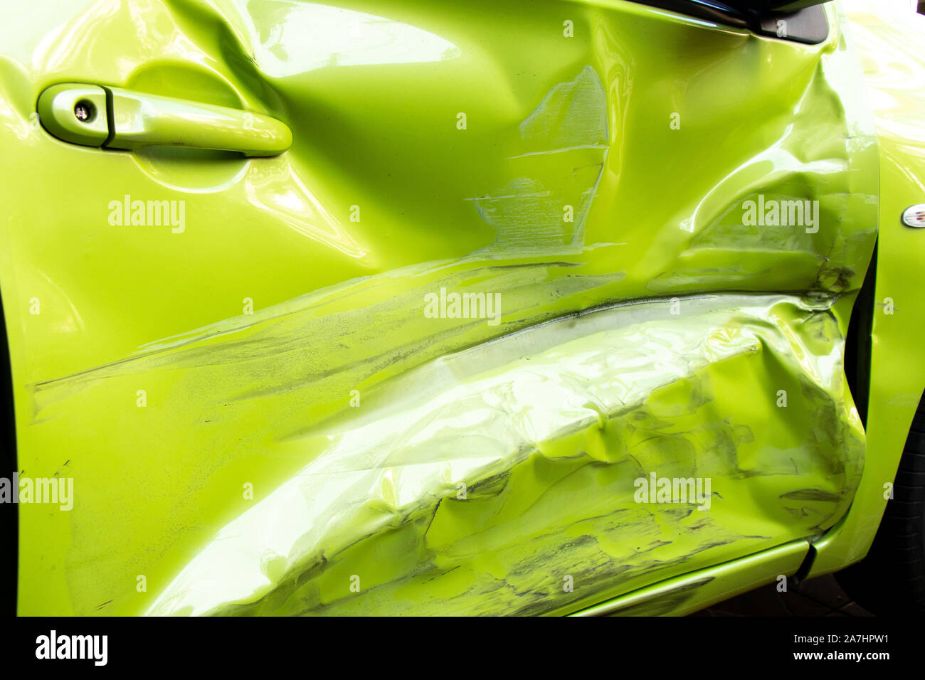 Closed up background of damaged green color door of car that caused ...