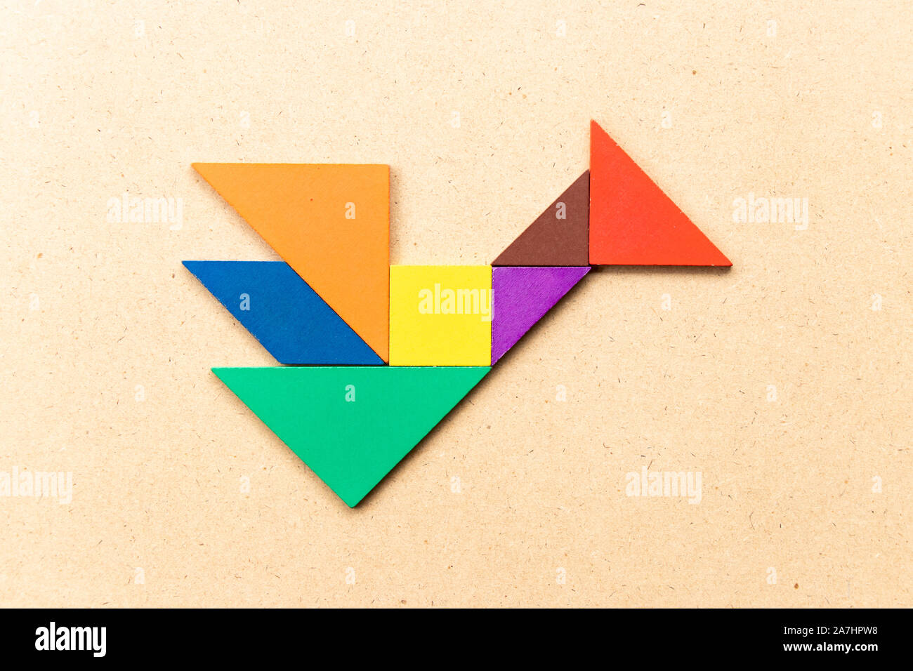 Color tangram puzzle in bird or dragon shape on wood background Stock ...