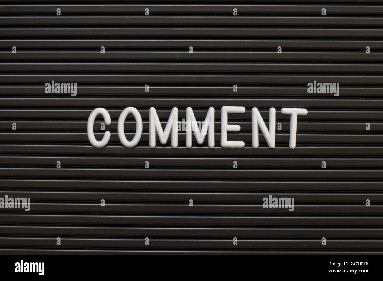 Black color felt letter board with white alphabet in word comment ...