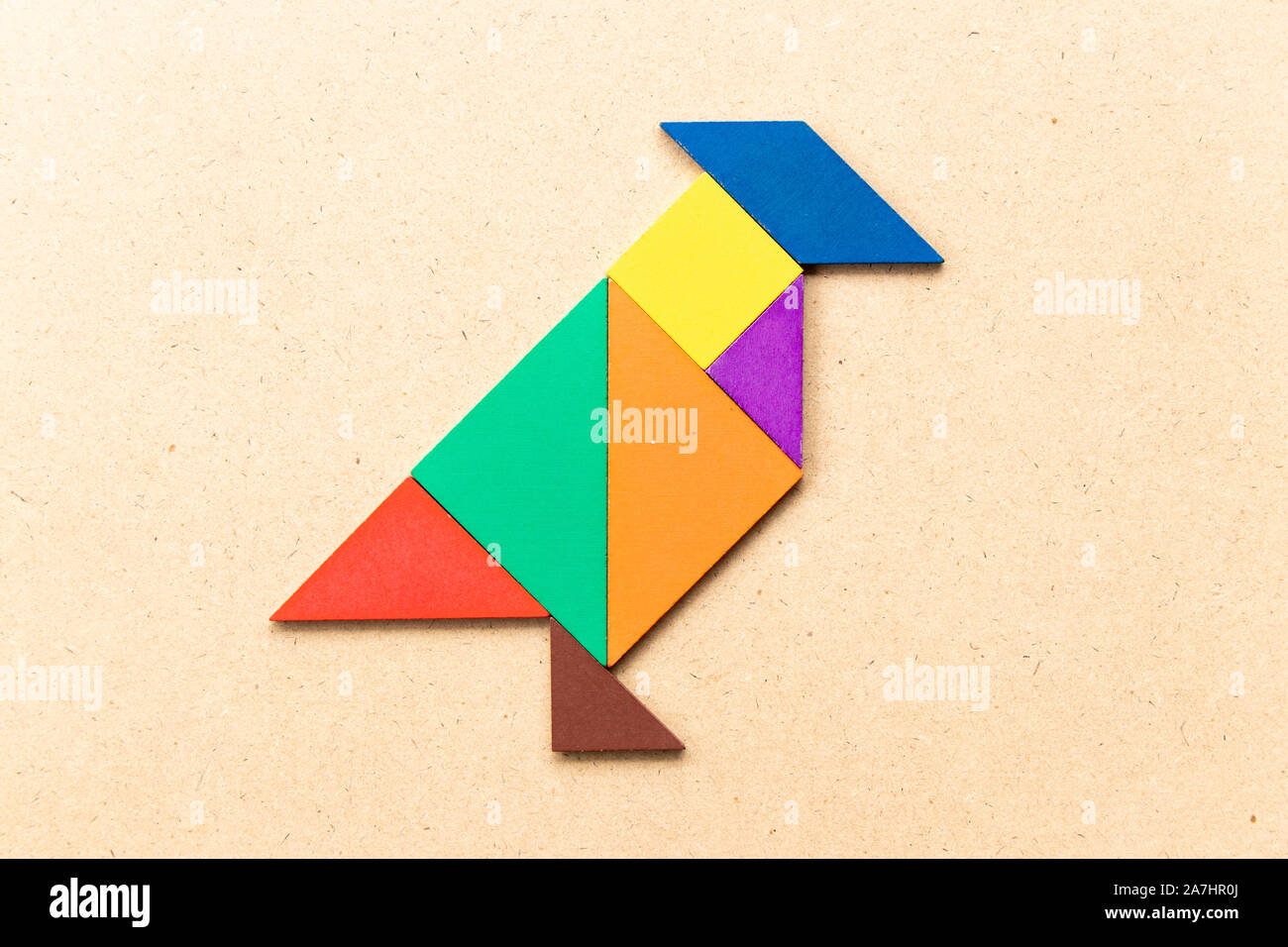 Color tangram puzzle in shape on wood background Stock Photo - Alamy