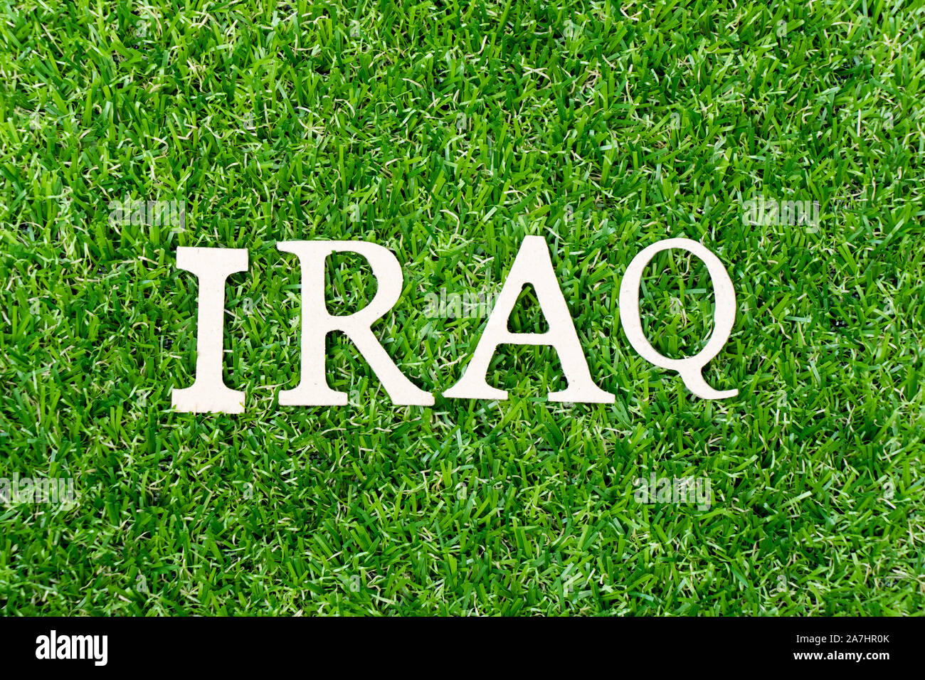 Wood letter in word Iraq on green grass background Stock Photo - Alamy