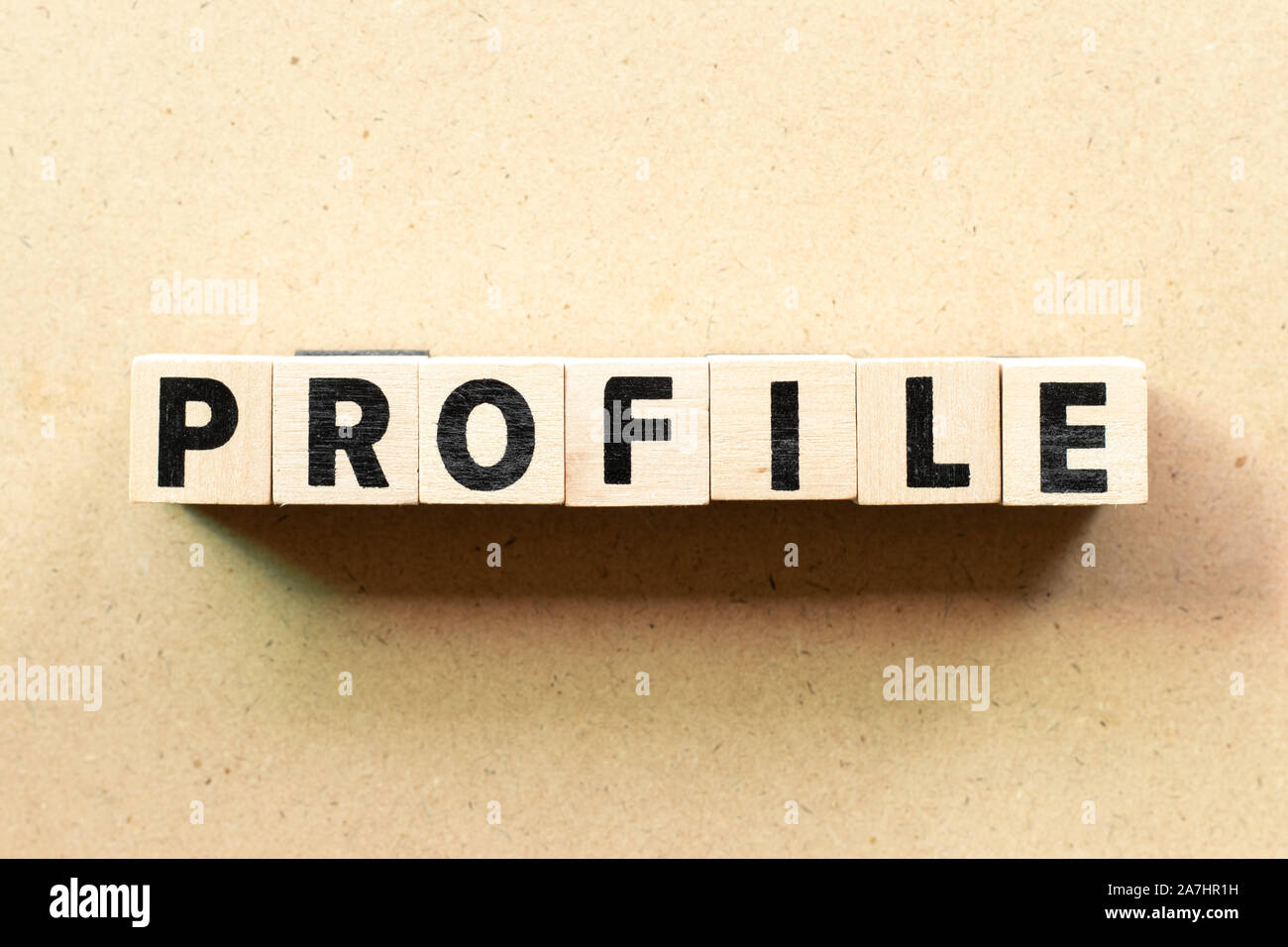 Letter block in word profile on wood background Stock Photo - Alamy