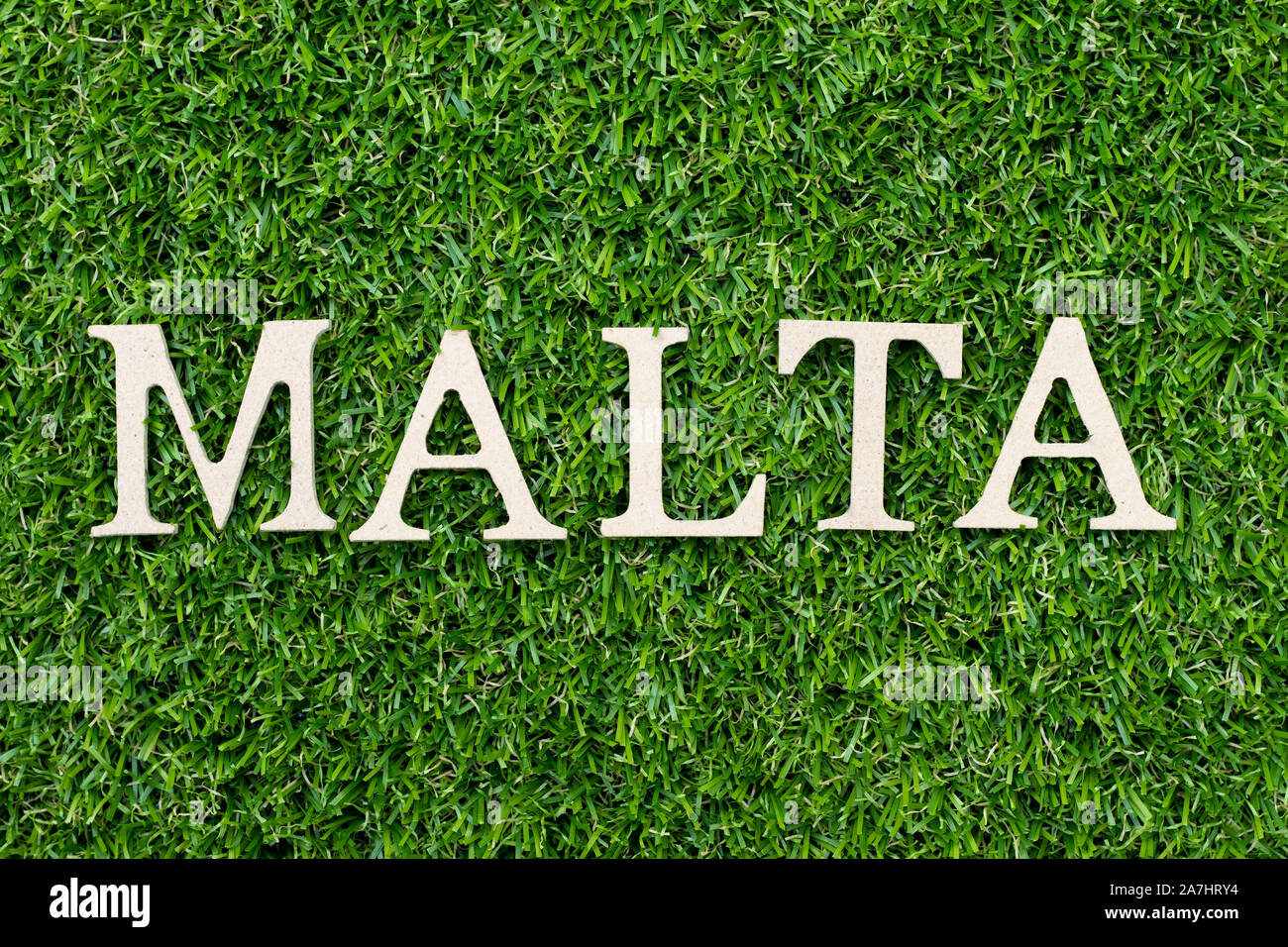 Wood alphabet letter in word Malta on green grass background Stock ...