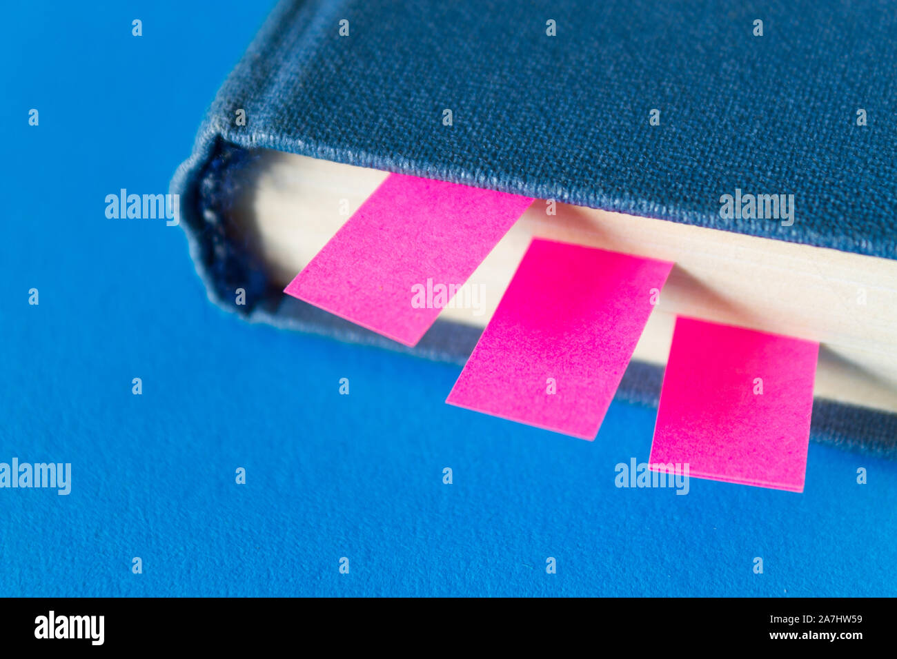 Book with many bookmarks inside it on blue background Stock Photo - Alamy