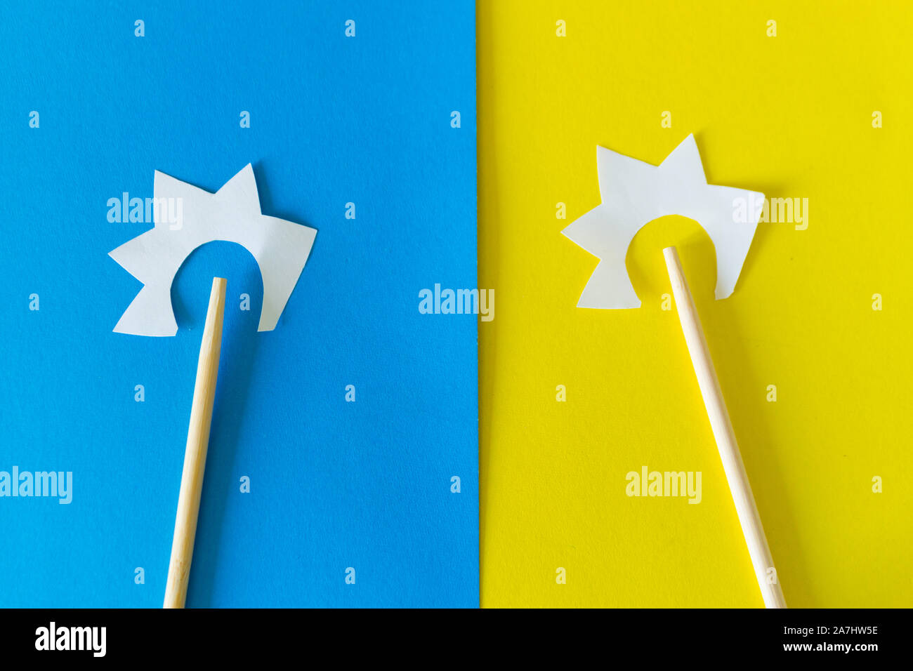 Confrontation concept image. Two magic sticks on different background ...