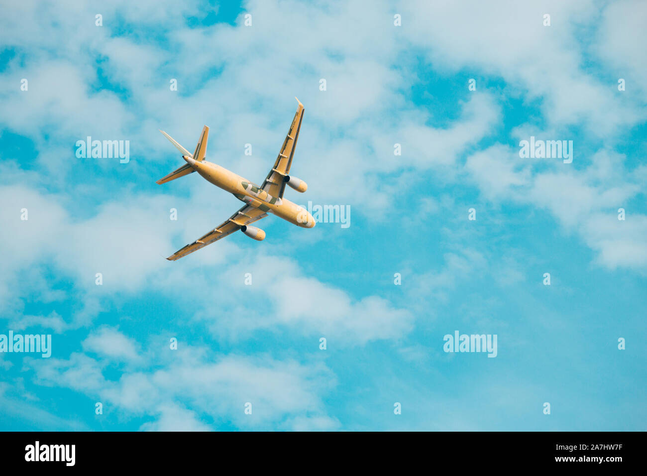 Airplane is flying in the blue sky Stock Photo - Alamy