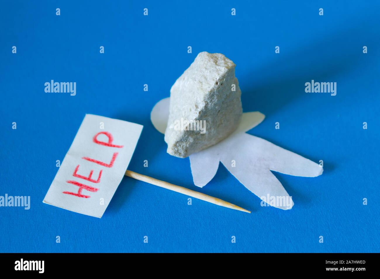 Person under a stone. Problems concept image Stock Photo - Alamy